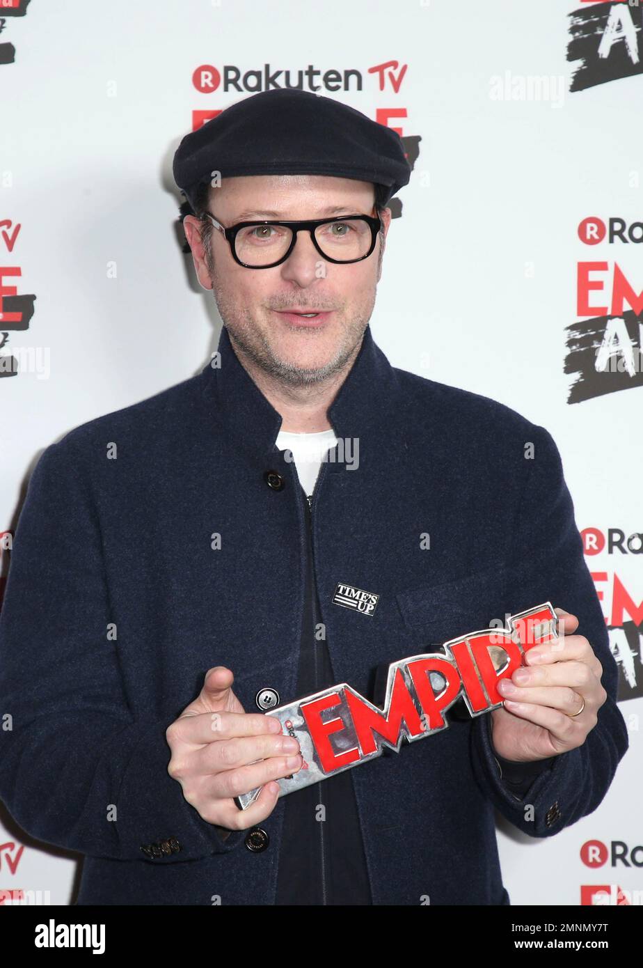 Director Matthew Vaughan poses for photographers with the award for ...