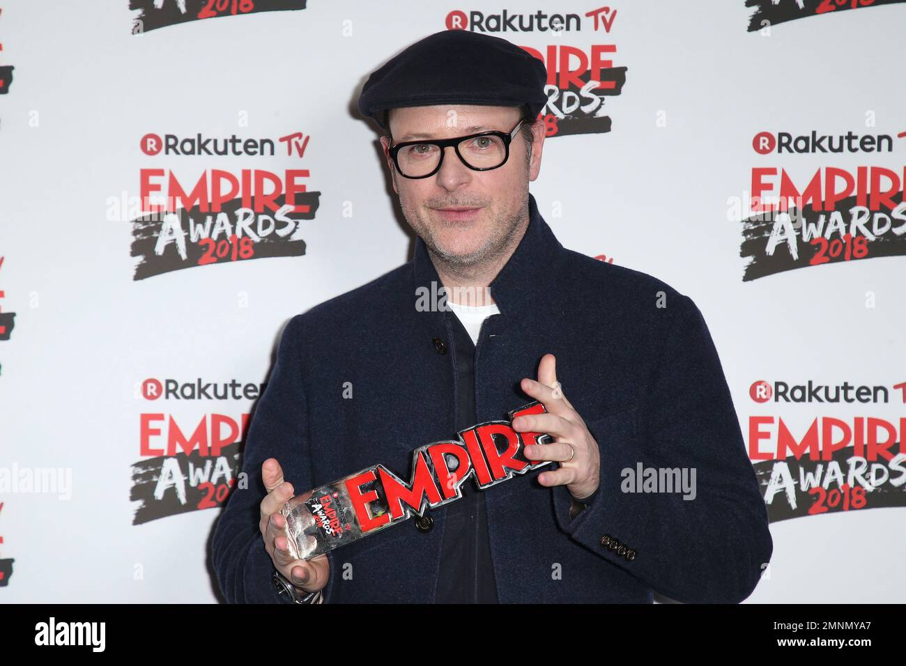 Director Matthew Vaughan poses for photographers with the award for ...