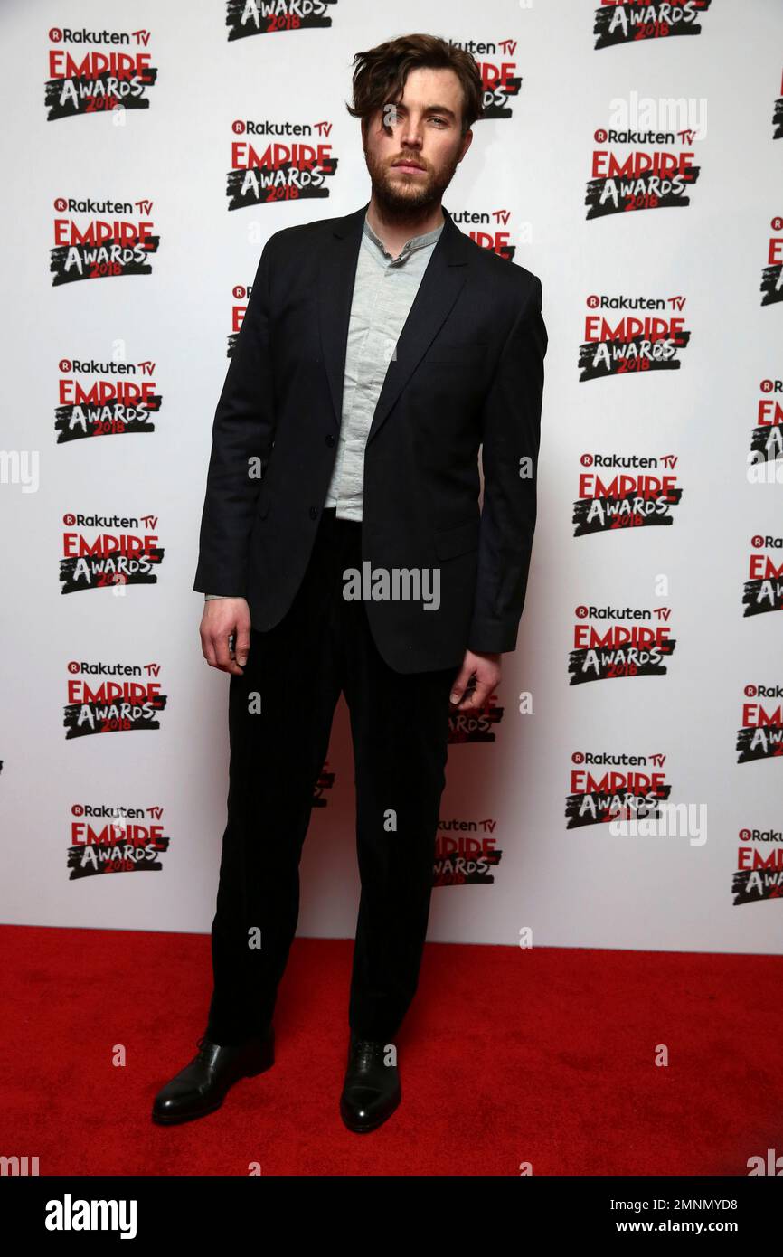 Actor Tom Hughes poses for photographers on arrival at the Empire Film ...