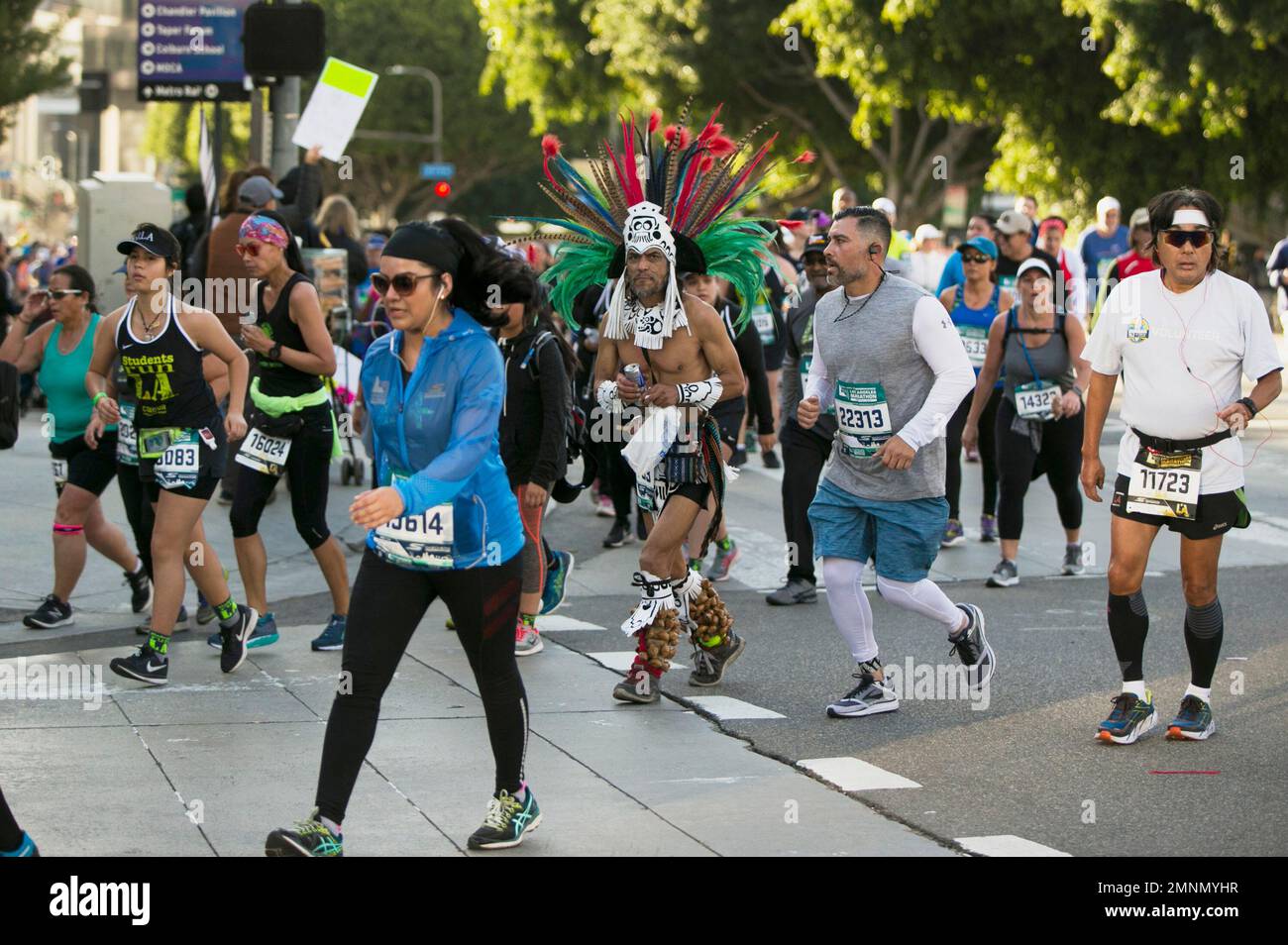 A runner dressed as an Aztec Conchero dancer, races at the Los Angeles ...