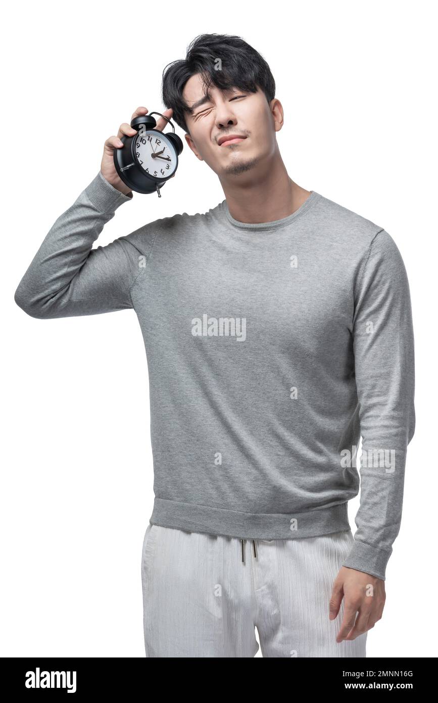The young man with an alarm clock Stock Photo - Alamy