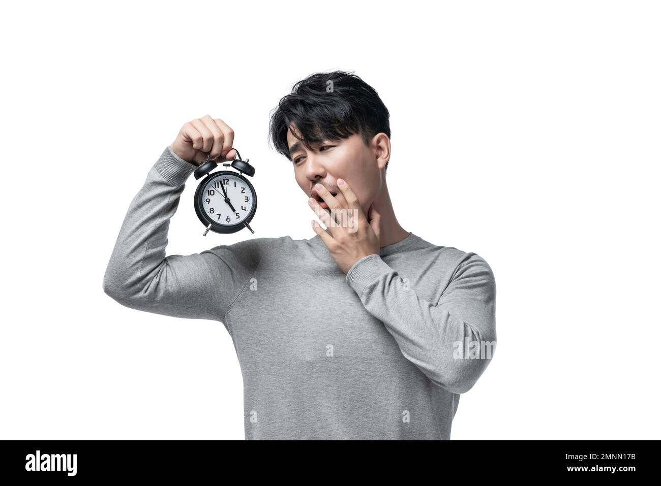 The young man with an alarm clock Stock Photo - Alamy