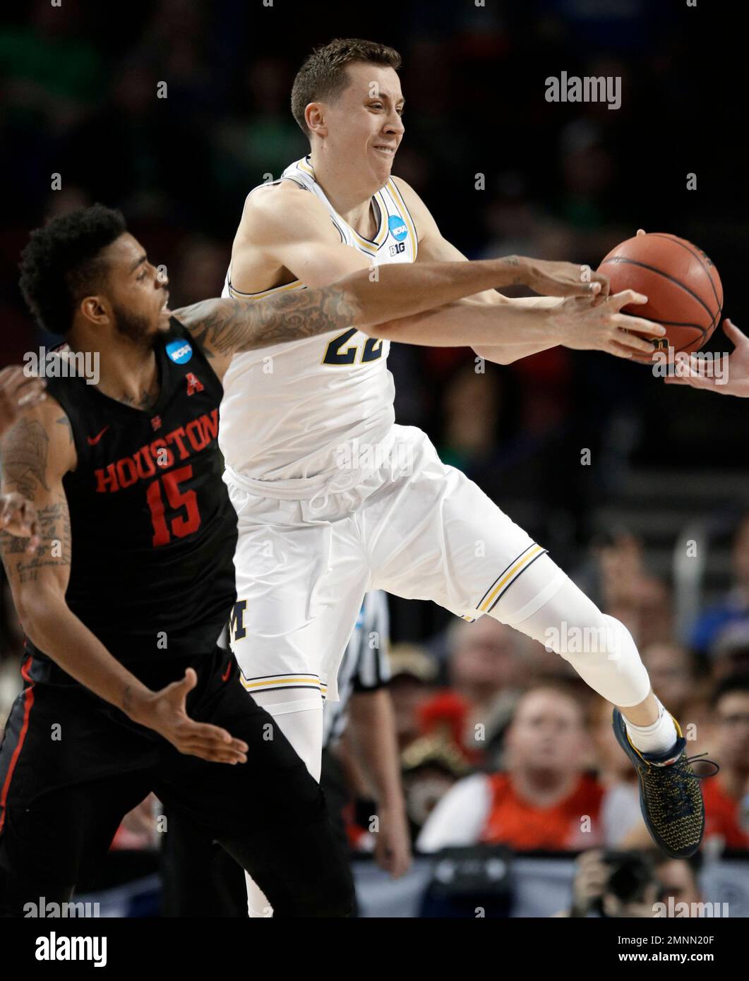 Michigan guard Duncan Robinson (22) reaches for the ball on a rebound ...