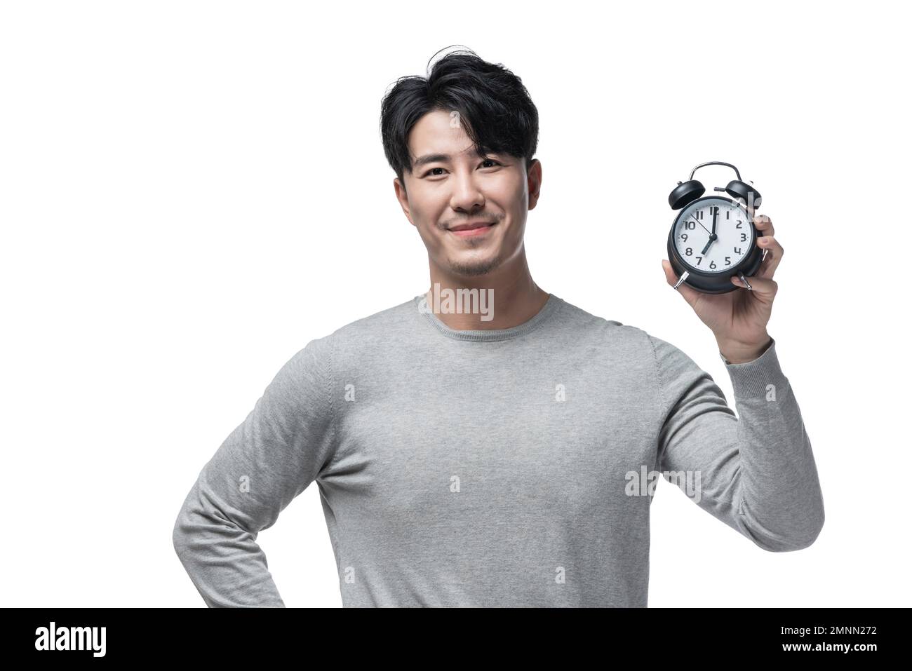 The young man with an alarm clock Stock Photo - Alamy