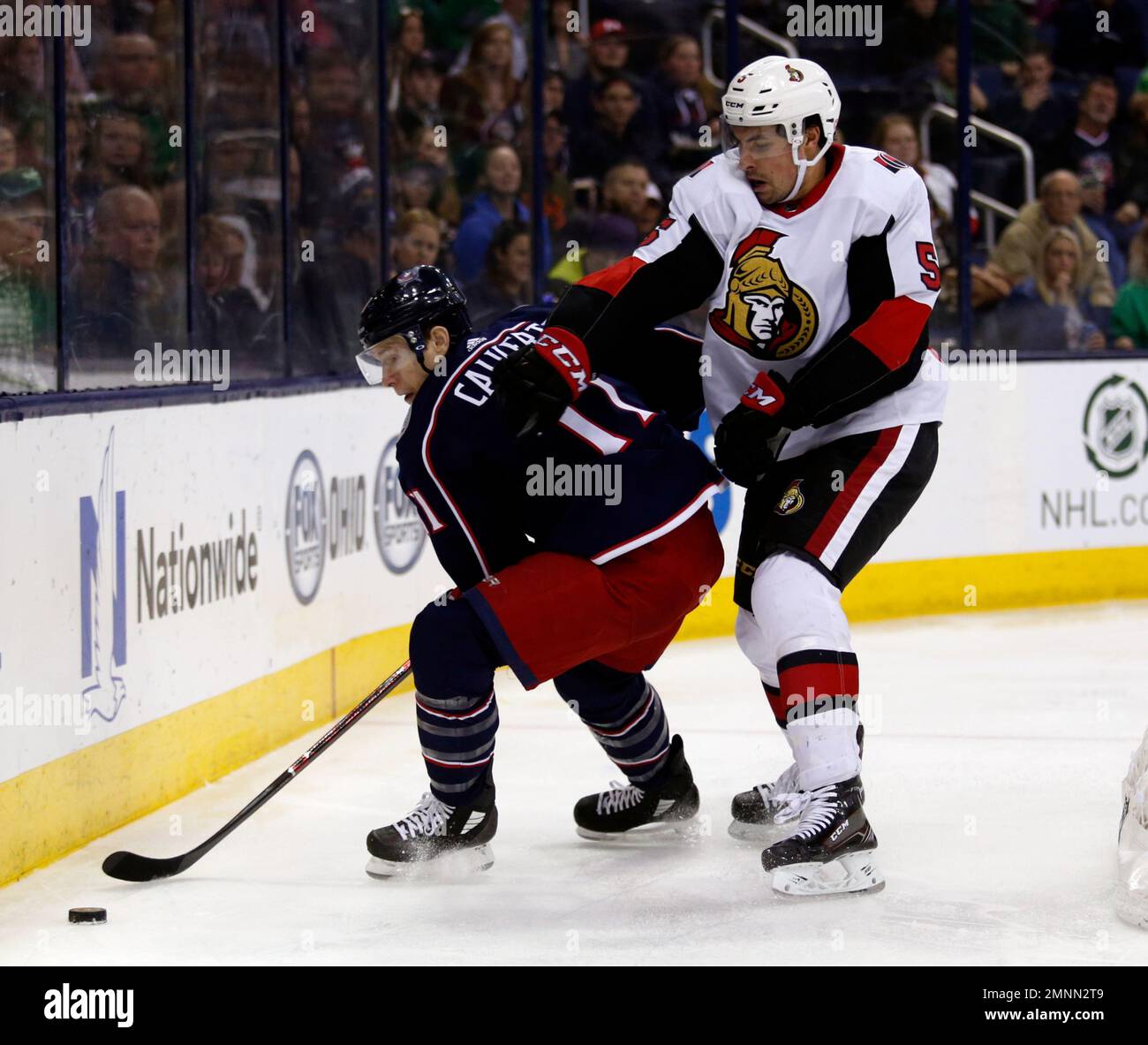 Columbus Blue Jackets forward Matt Calvert, left, works against Ottawa ...