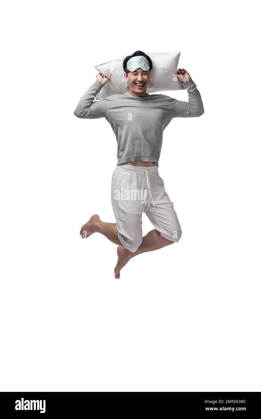 The young man holding a pillow Stock Photo - Alamy
