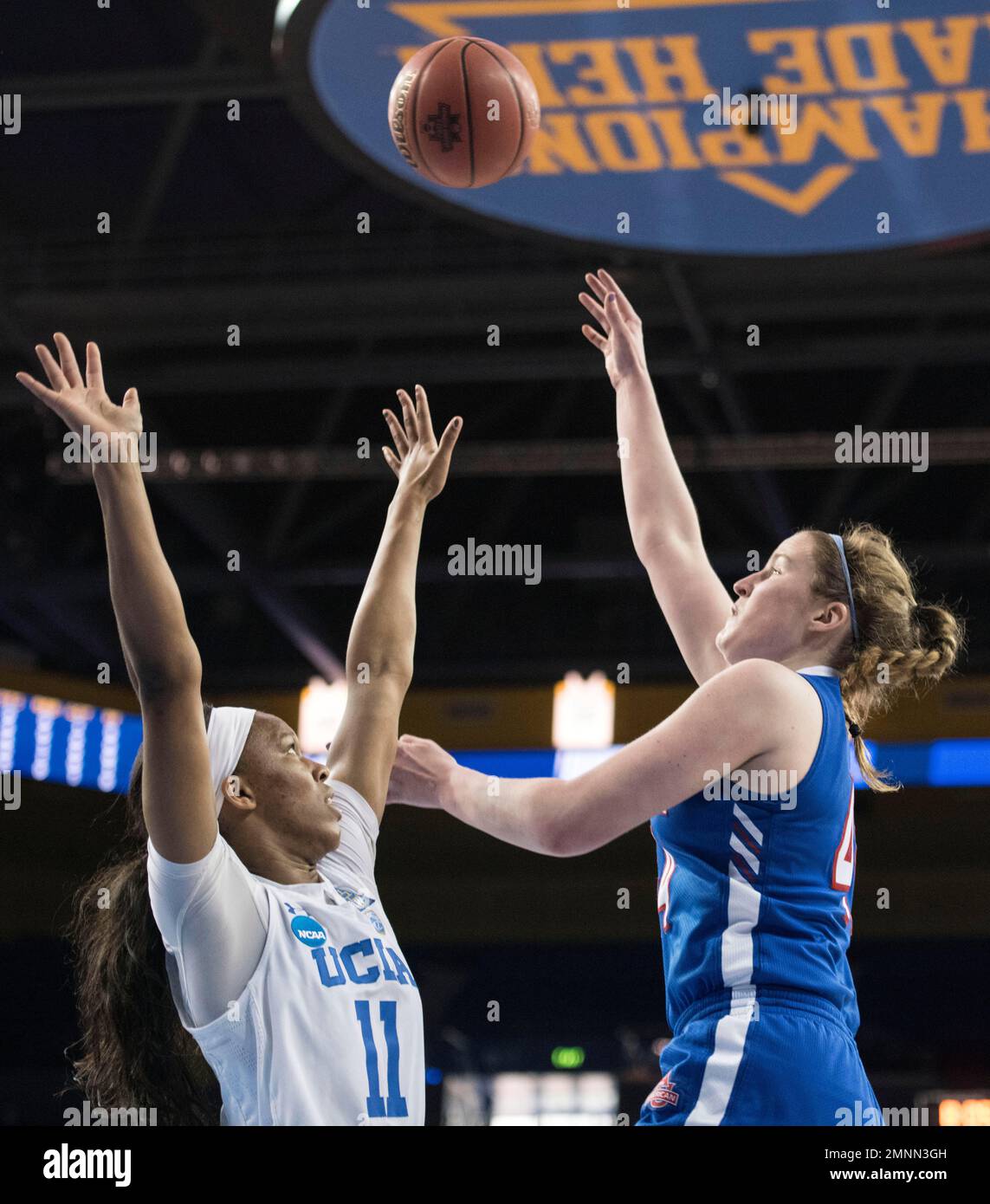 American forward Cecily Carl, right, shoots over UCLA forward Lajahna ...