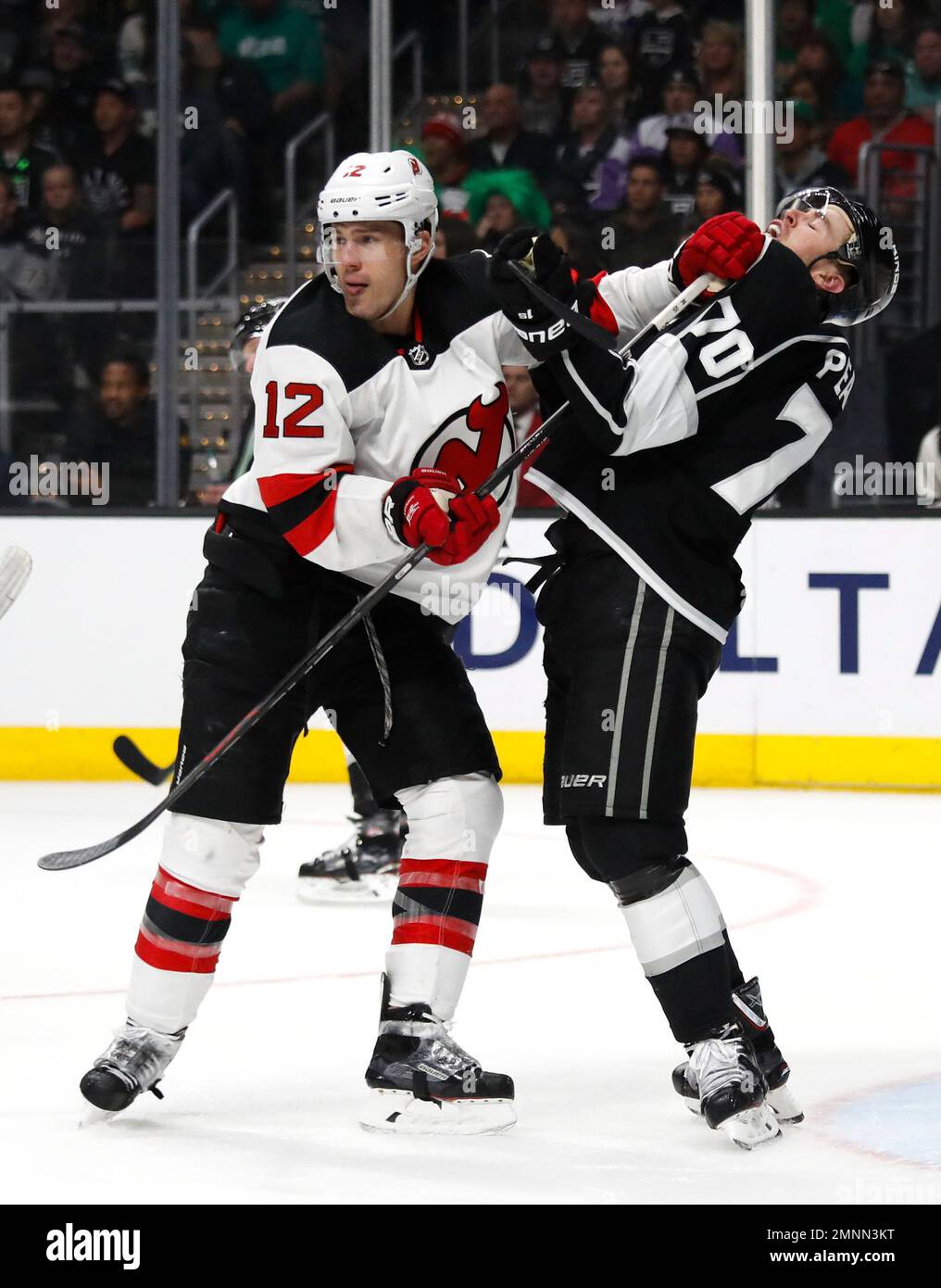 New Jersey Devils' Ben Lovejoy, left, shoves Los Angeles Kings' Tanner ...