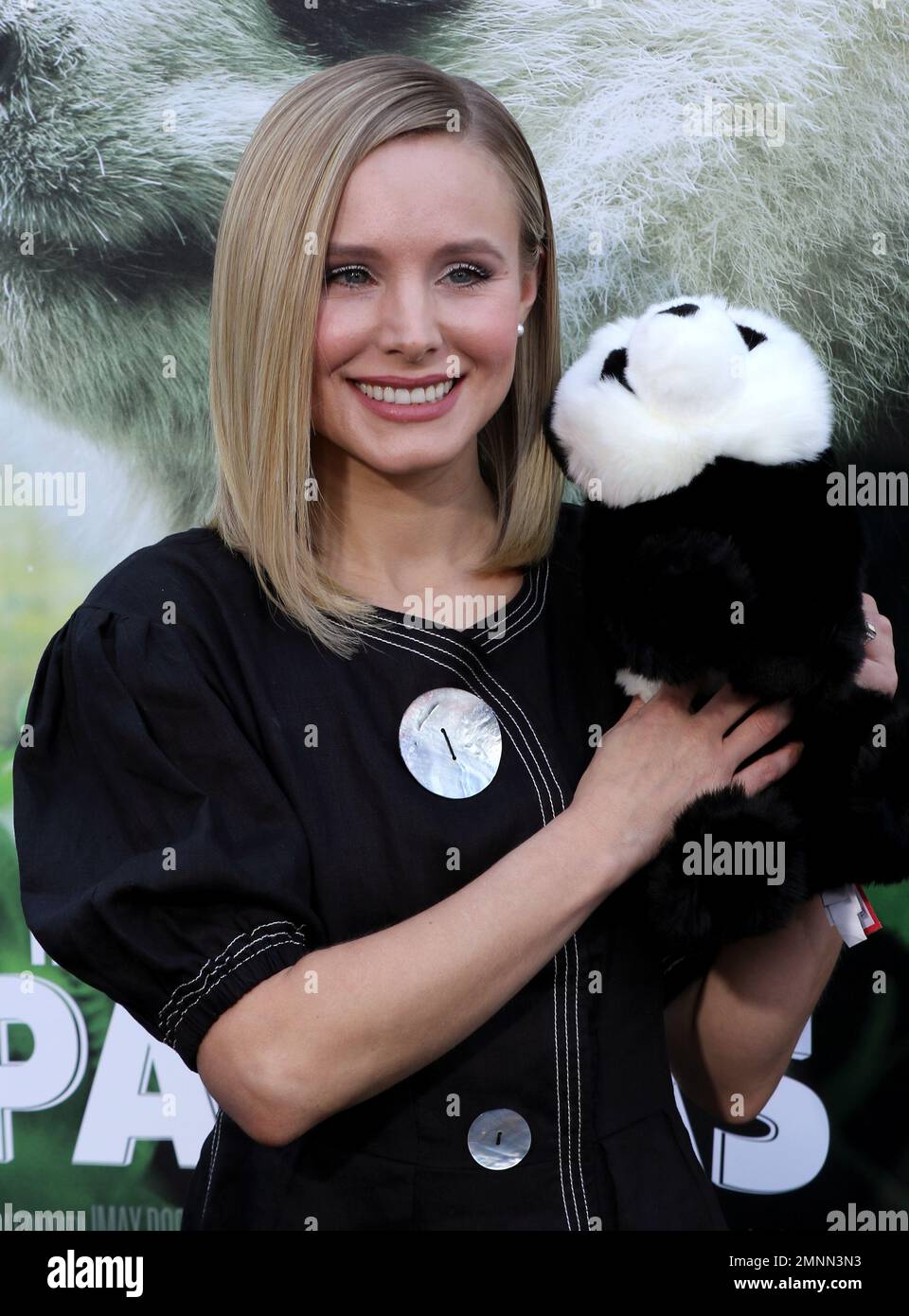 Kristen Bell holds a panda teddy bear at the LA Premiere of "Pandas" at ...