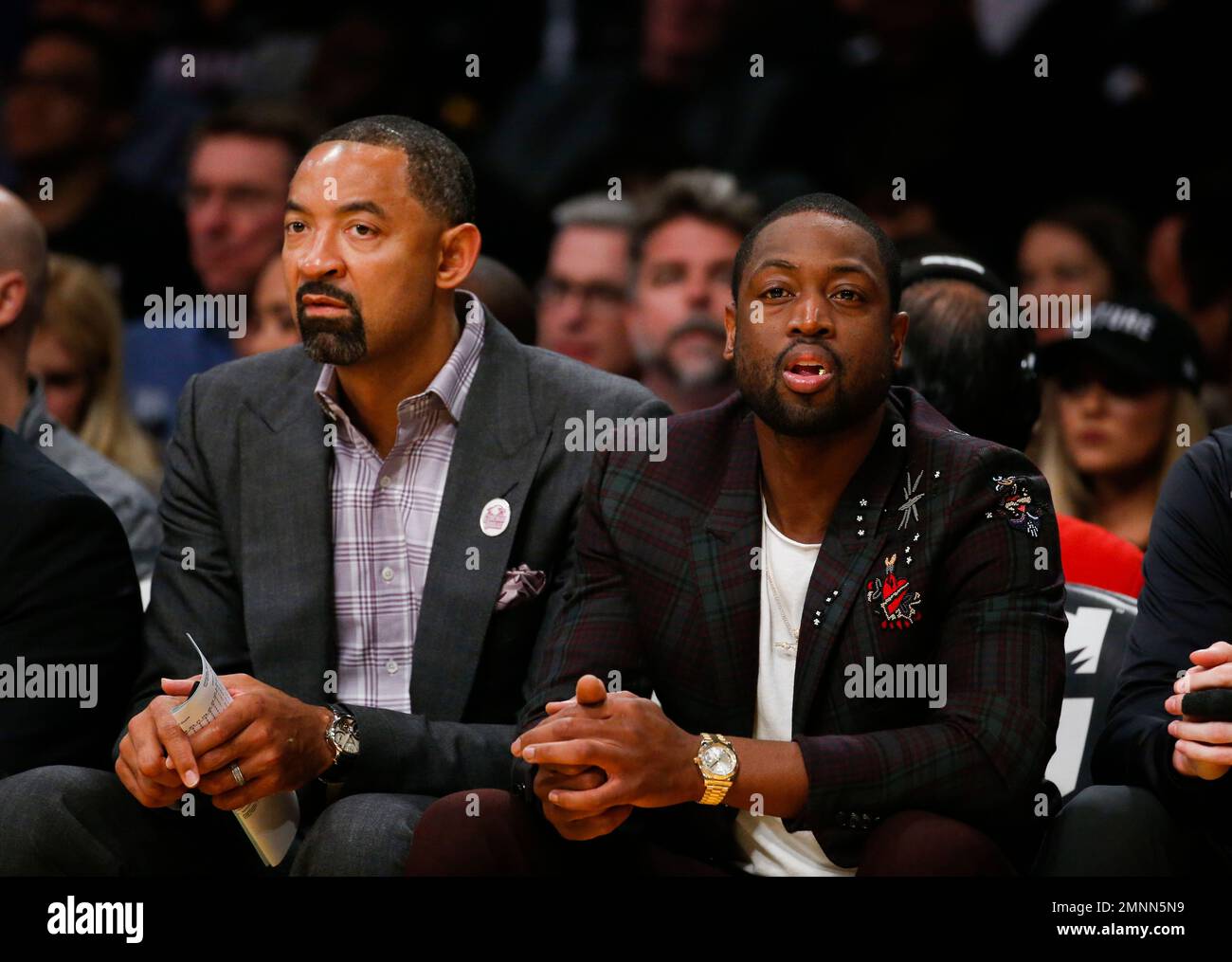 Miami Heat guard Dwyane Wade, right, and Juwan Howard on bench watch an ...