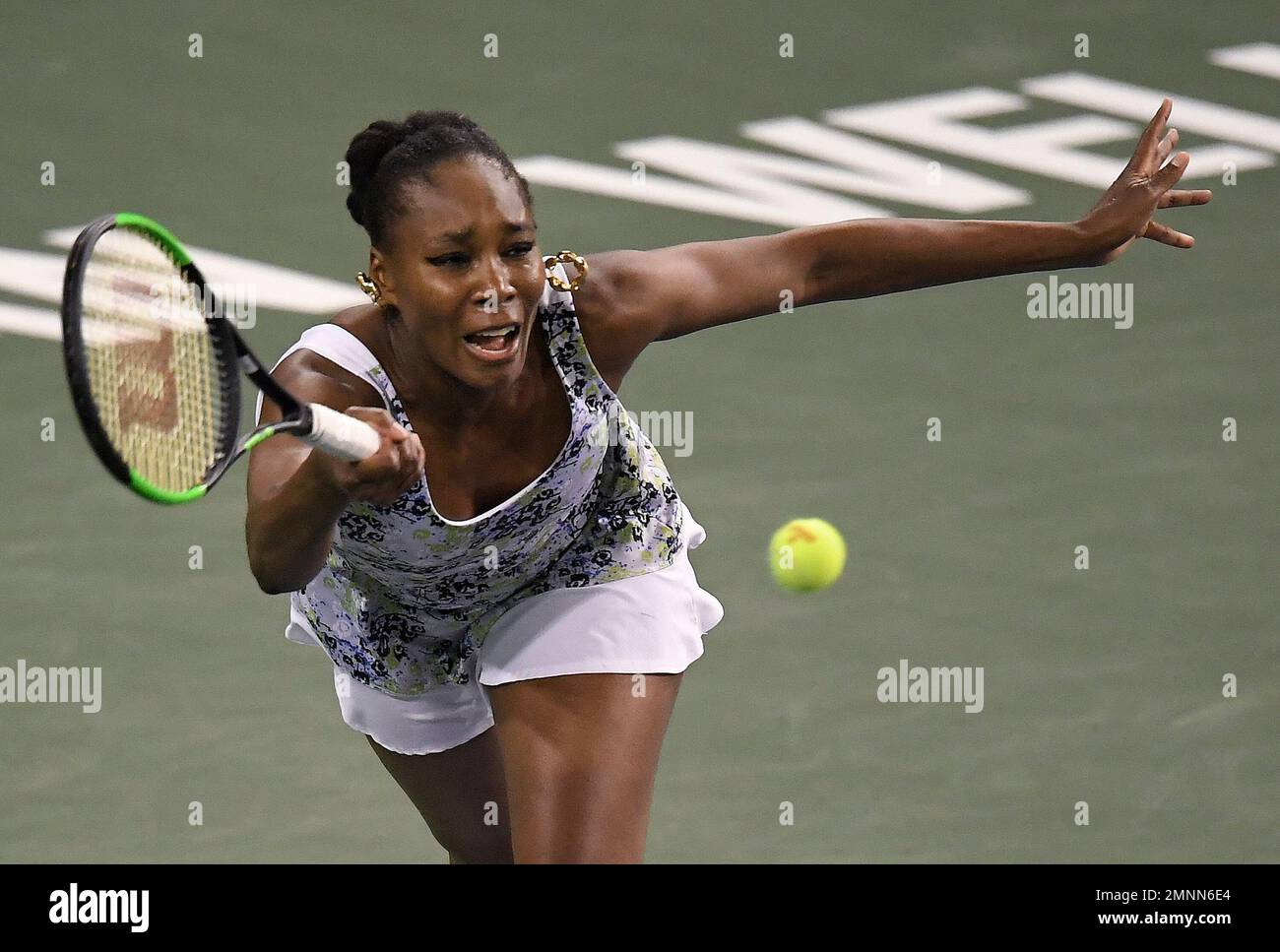 Venus Williams, of the United States, hits a forehand to Daria ...
