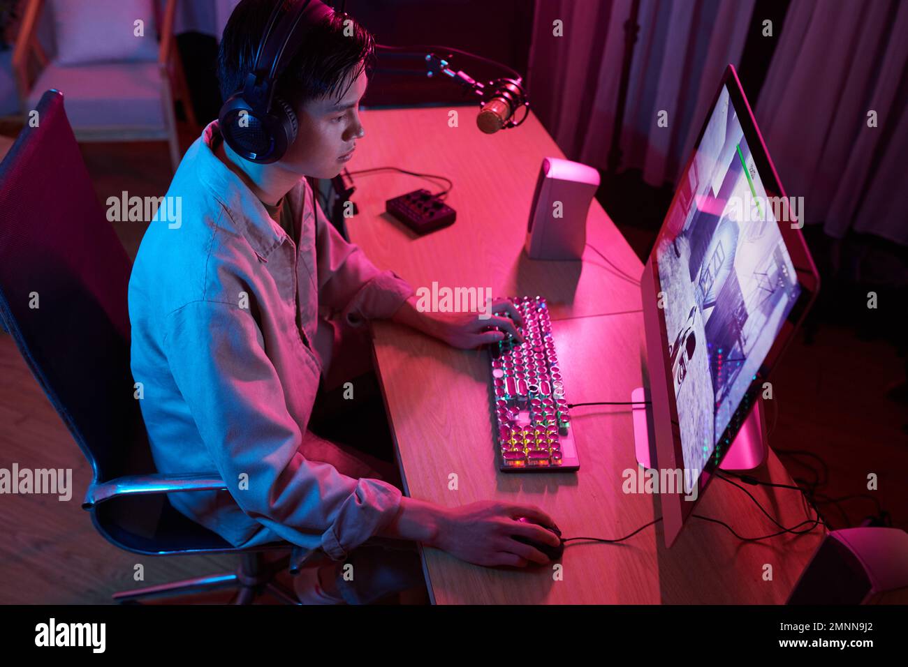 Serious teenage boy playing game on computer at home Stock Photo - Alamy