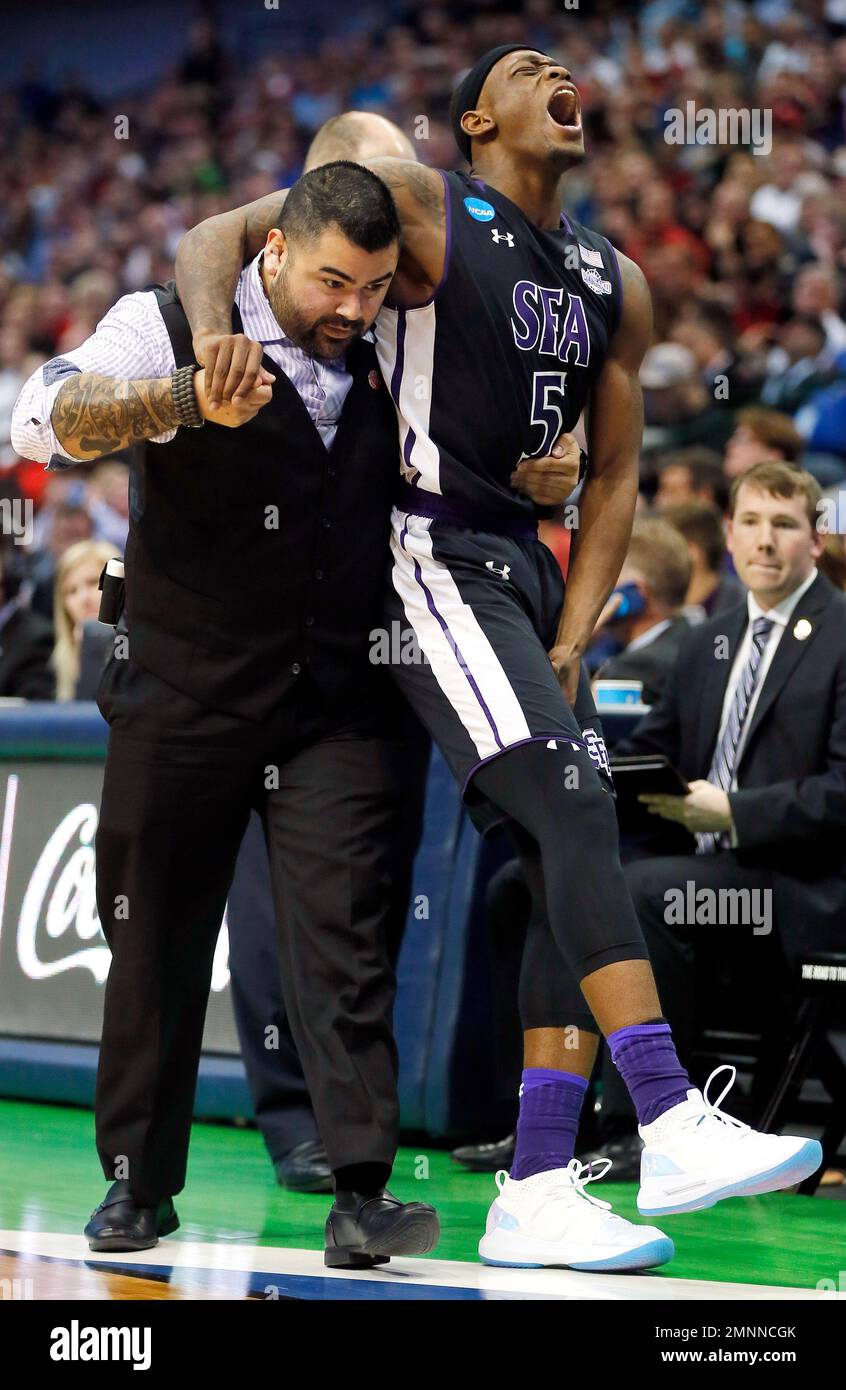 Stephen F. Austin guard Shannon Bogues (5) is helped off the court ...