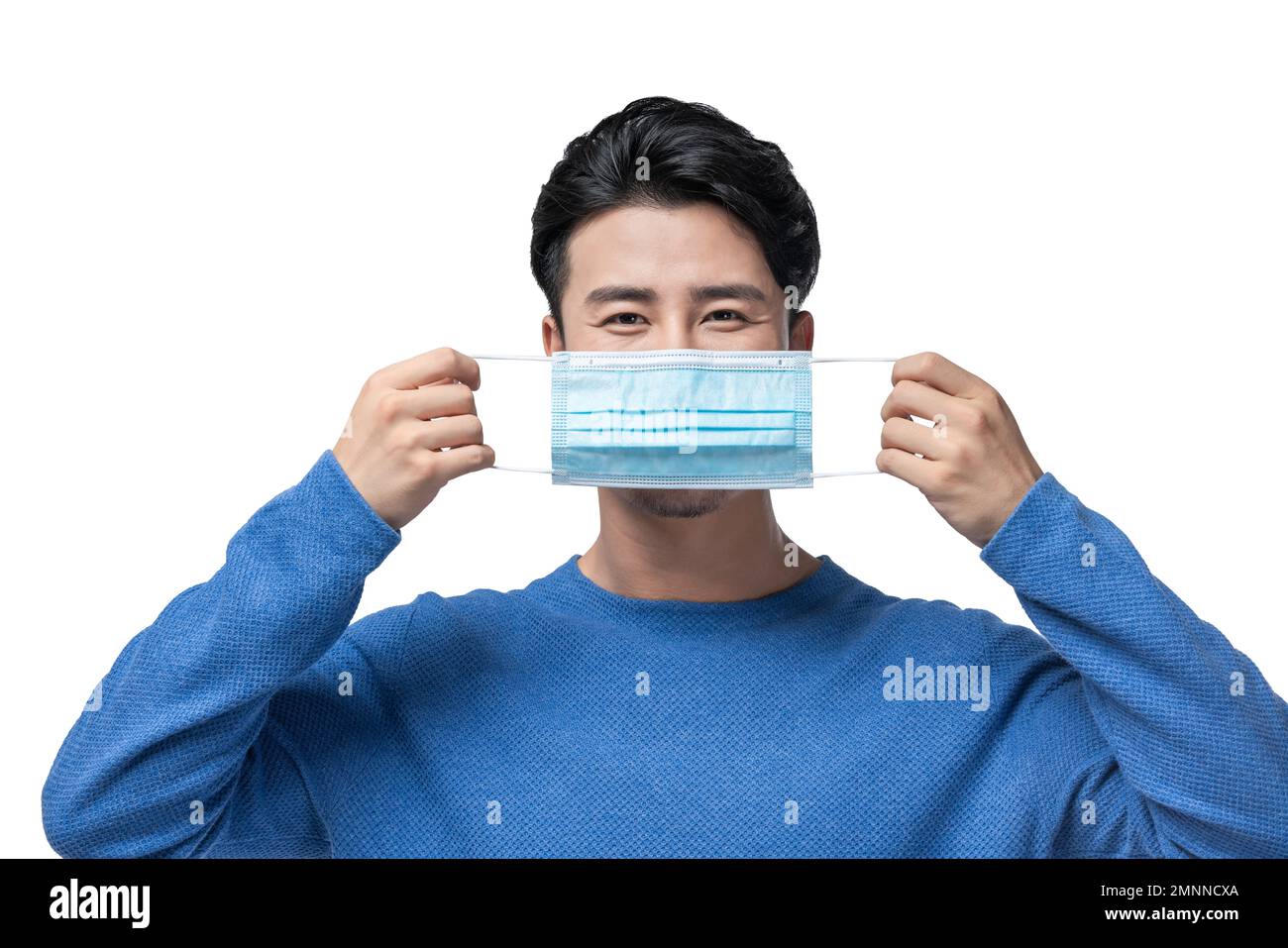 The young man holding a surgical mask Stock Photo - Alamy
