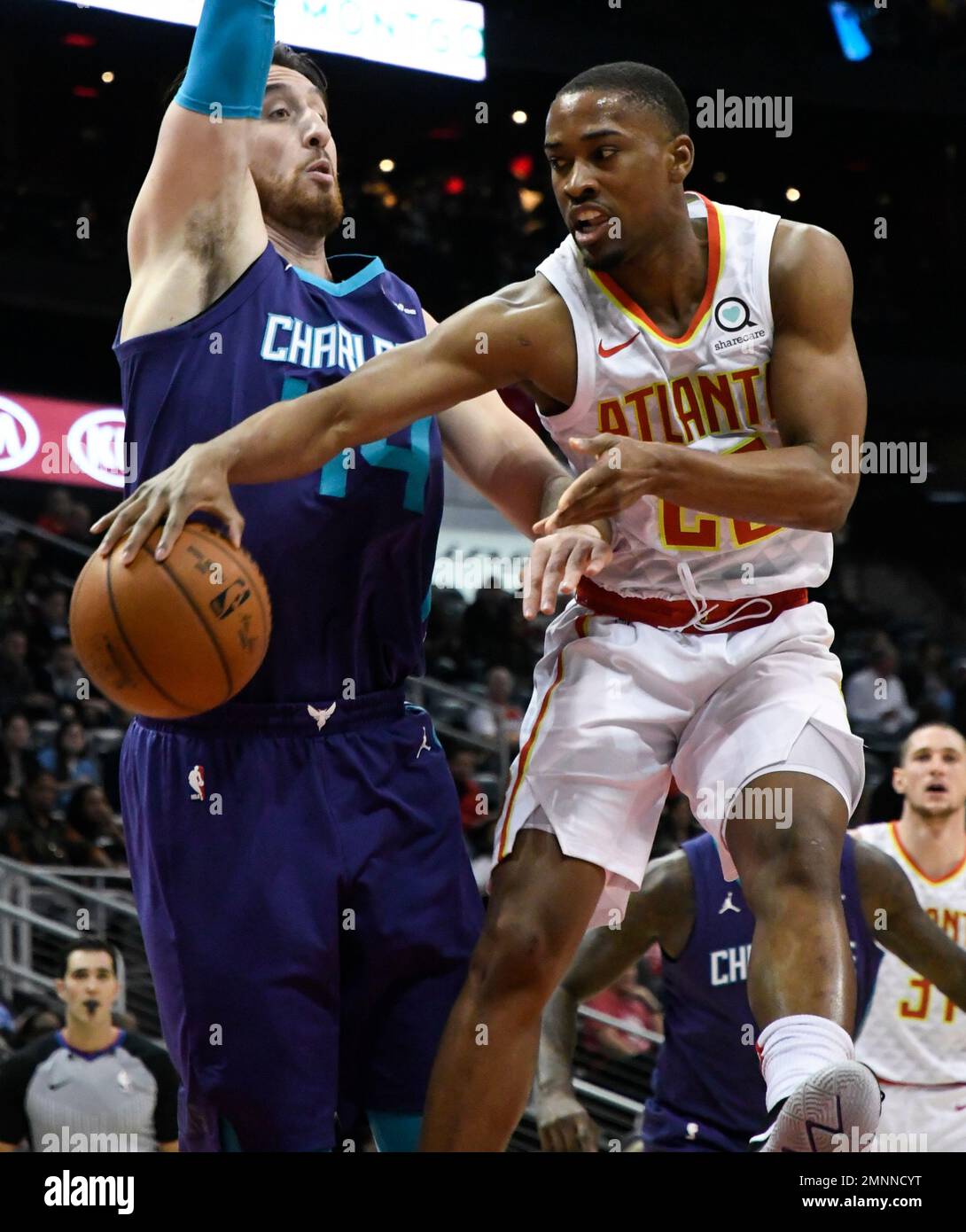 Atlanta Hawks guard Isaiah Taylor, right, attempts to around the back ...
