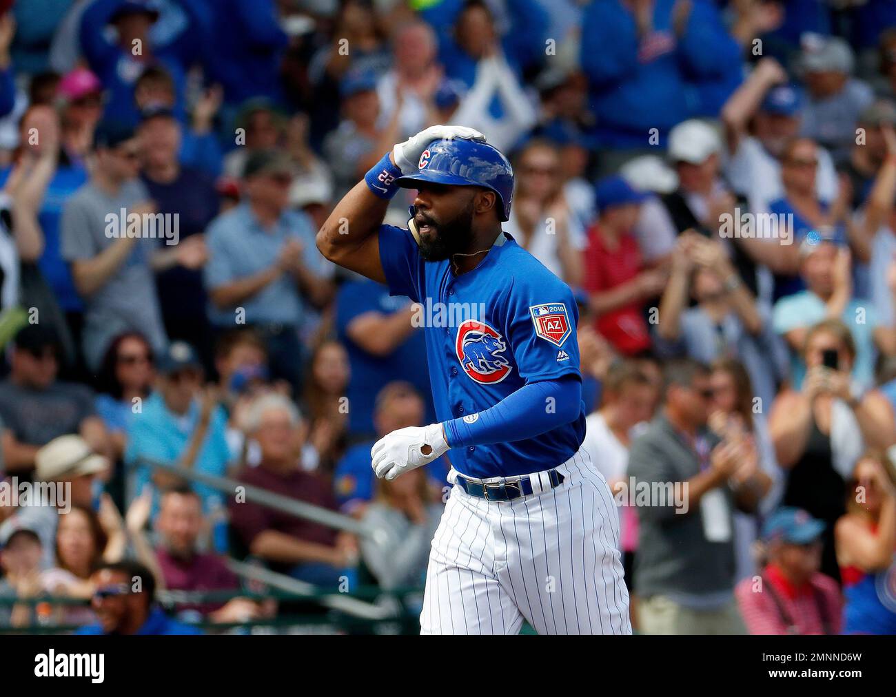 Chicago Cubs' Jason Hayward grabs his helmet after hitting a home run ...