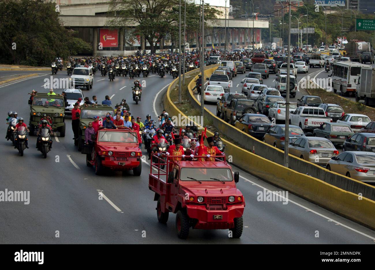 A military vehicle painted in red and carrying an eternal flame heads a ...