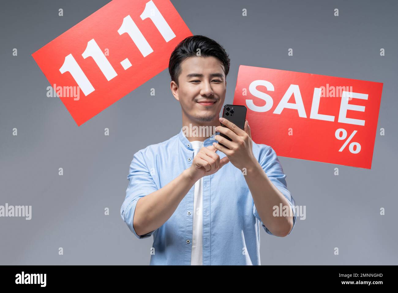 The young man holding a mobile phone Stock Photo - Alamy