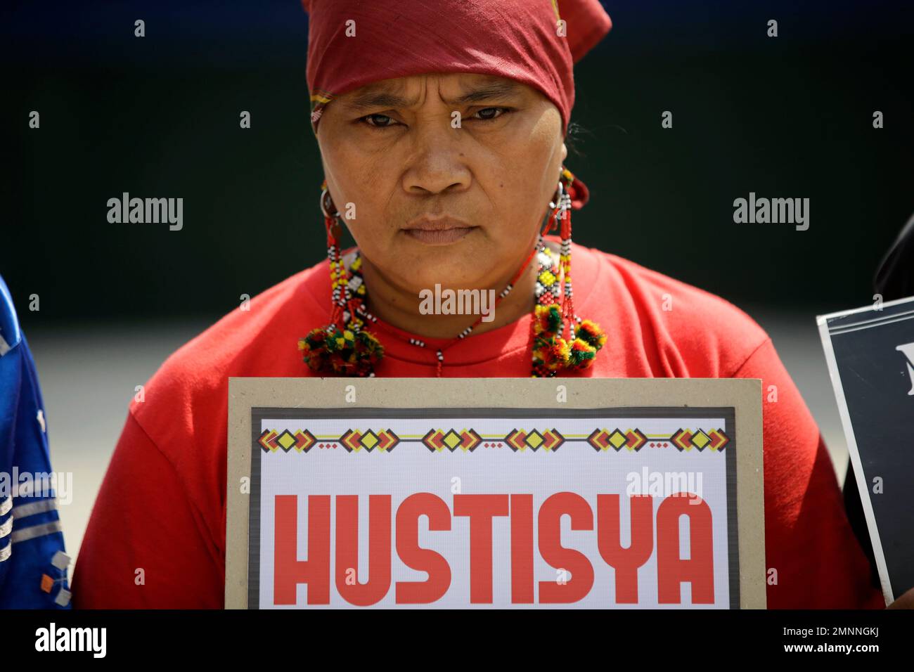 Filipino indigenous people known as Lumads hold a slogan that reads ...