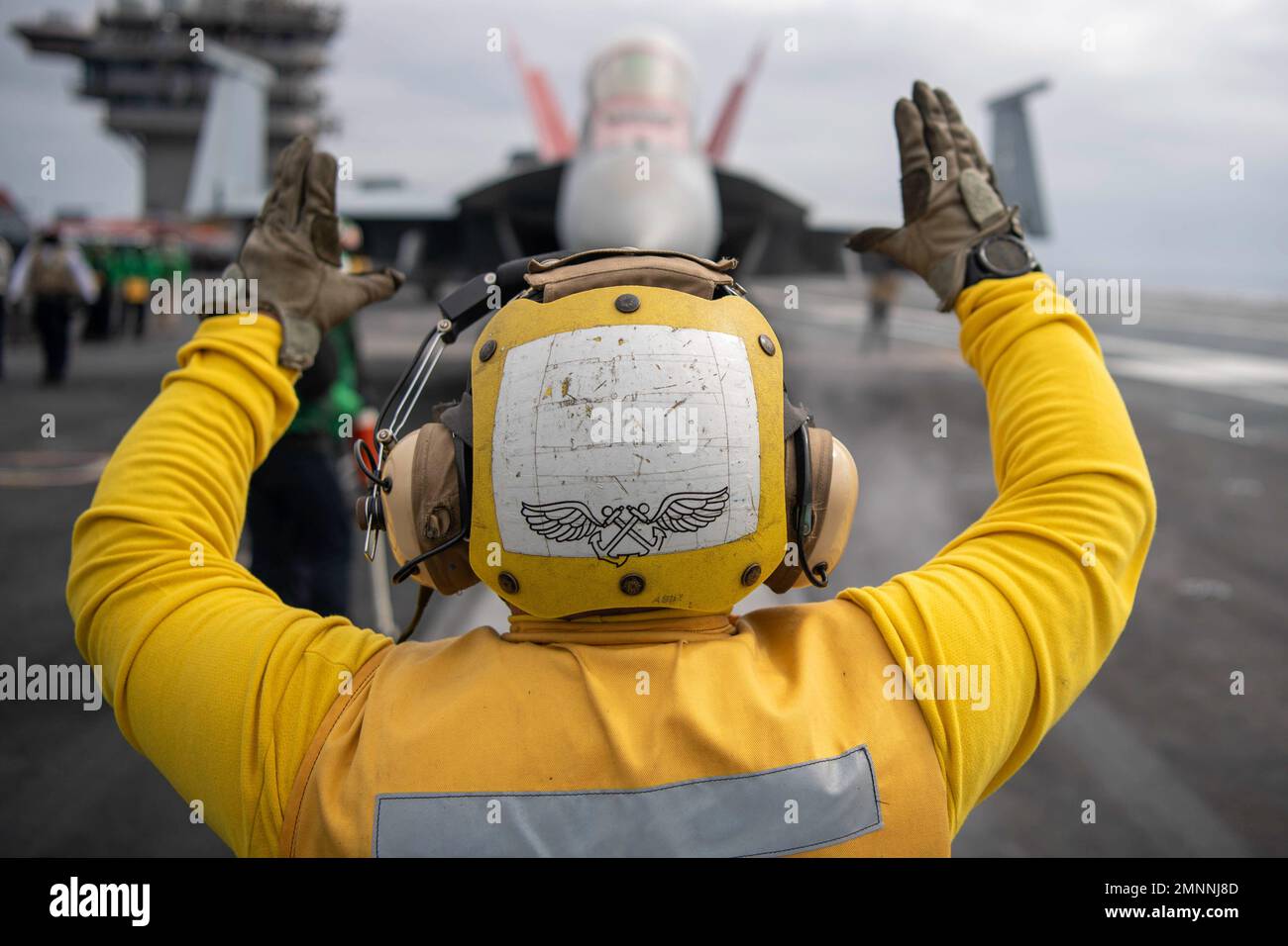 221004-N-DU622-1367 PACIFIC OCEAN (Oct. 4, 2022) A sailor directs an F/A-18F Super Hornet, from ...