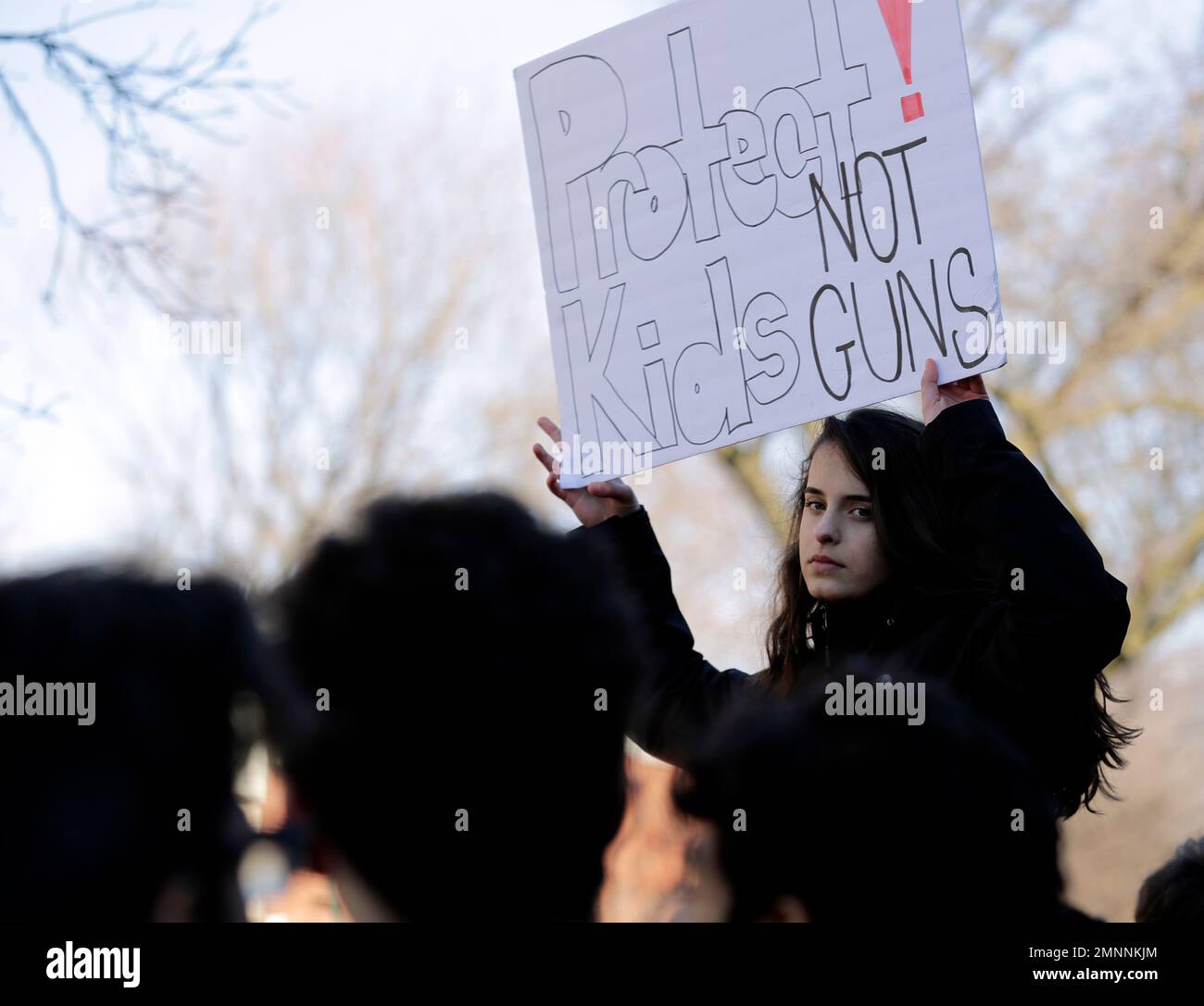 A student holds a sign during a walkout to protest gun violence at ...