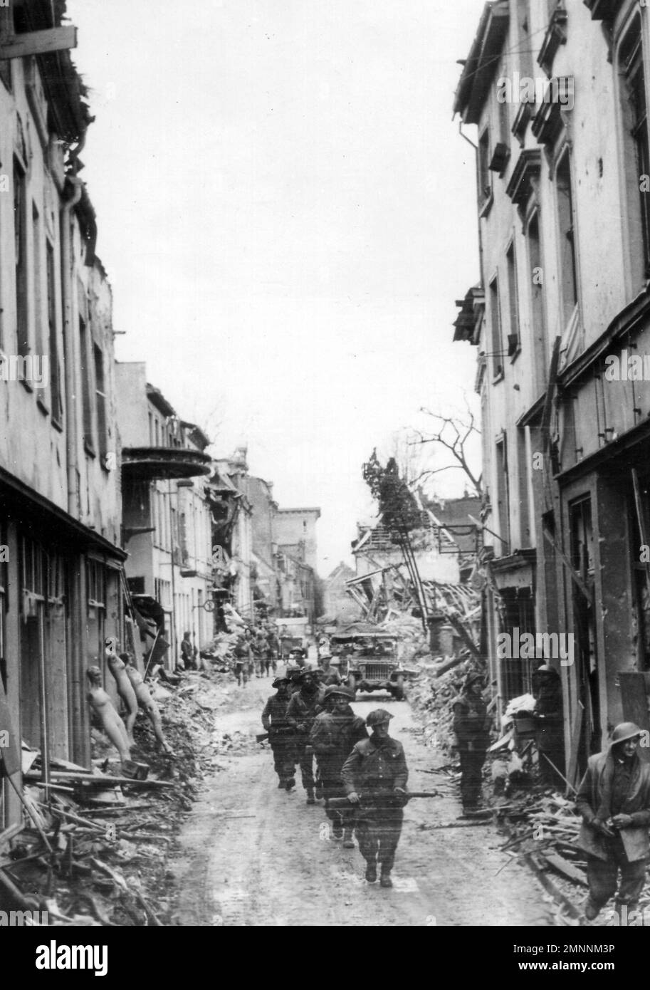A patrol of British troops cautiously advances through the wrecked ...