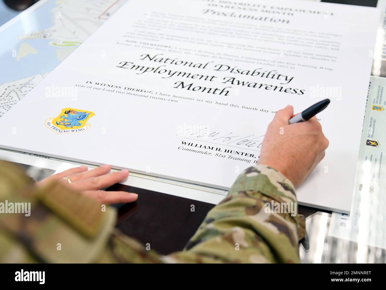U.S. Air Force Col. William Hunter, 81st Training Wing commander, signs ...