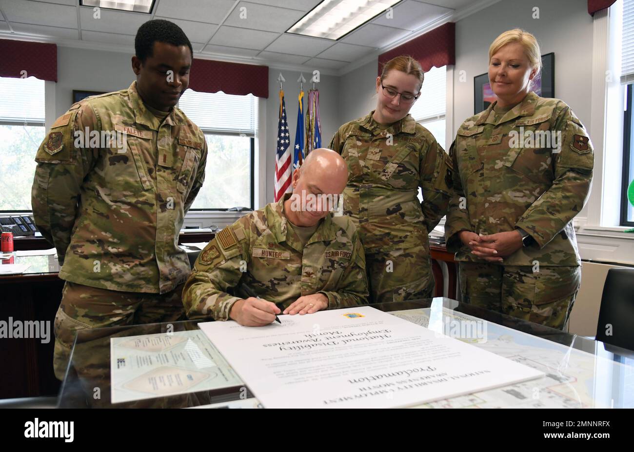 U.S. Air Force Col. William Hunter, 81st Training Wing commander, signs ...