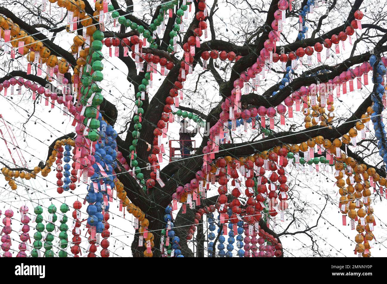 A worker attaches a name tag of a Buddhist who made donation to a ...