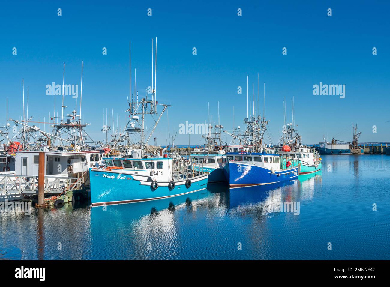 Corlorful fishing boats at the fishing village of Meteghan Harbour ...