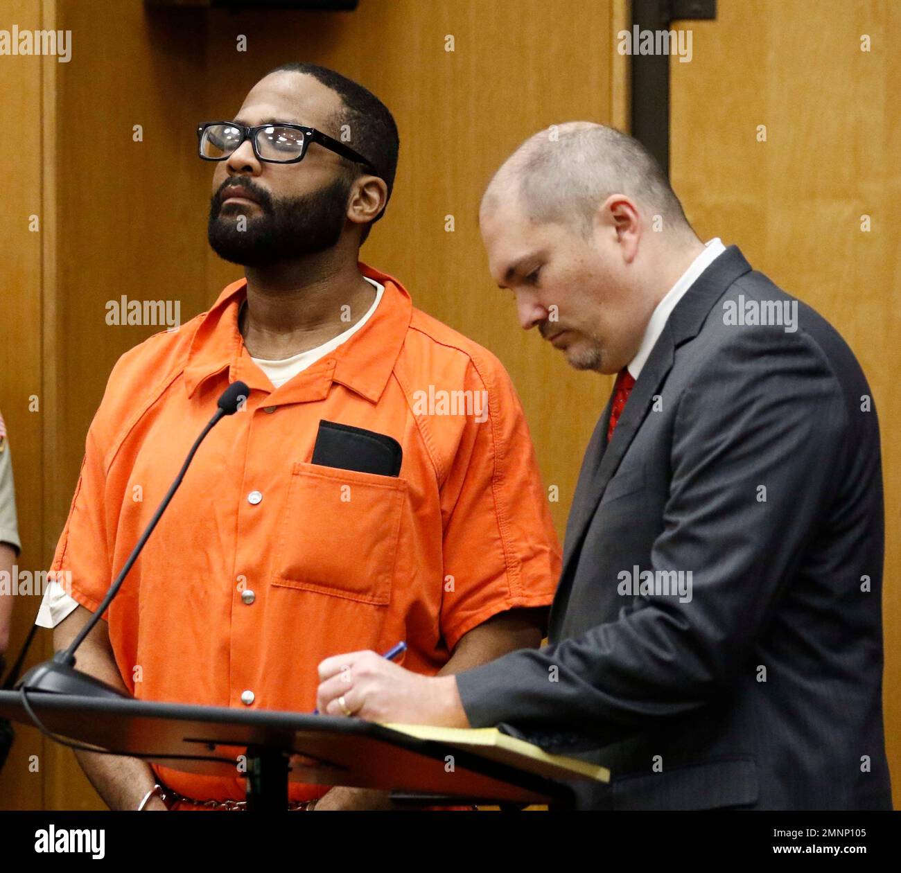Willie Cory Godbolt, left, closes his eyes, while standing next to his ...