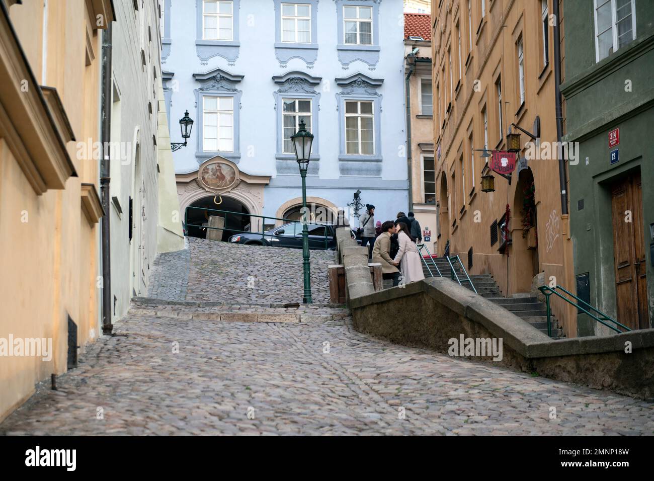 Couple kissing in cobblestone street between Sporkova and Nerudova ...