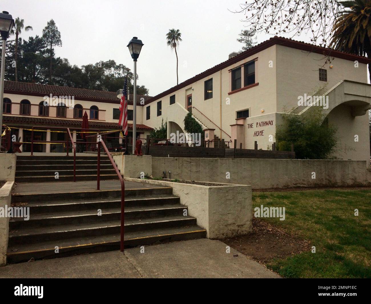 Yellow police tape surrounds Pathway Home, multilevel, vanilla-colored ...