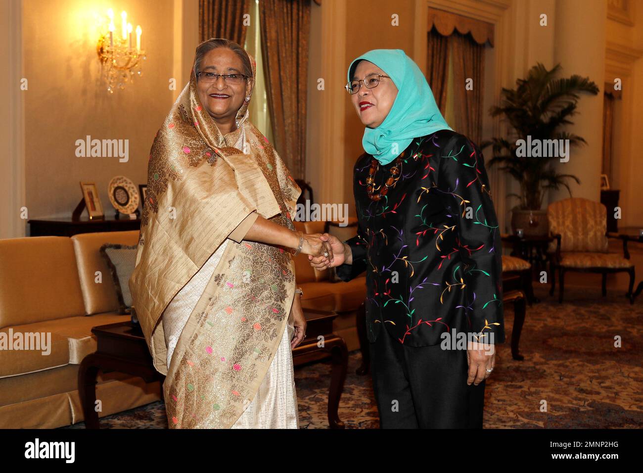 Bangladesh Prime Minister Sheikh Hasina, left, shakes hands with ...