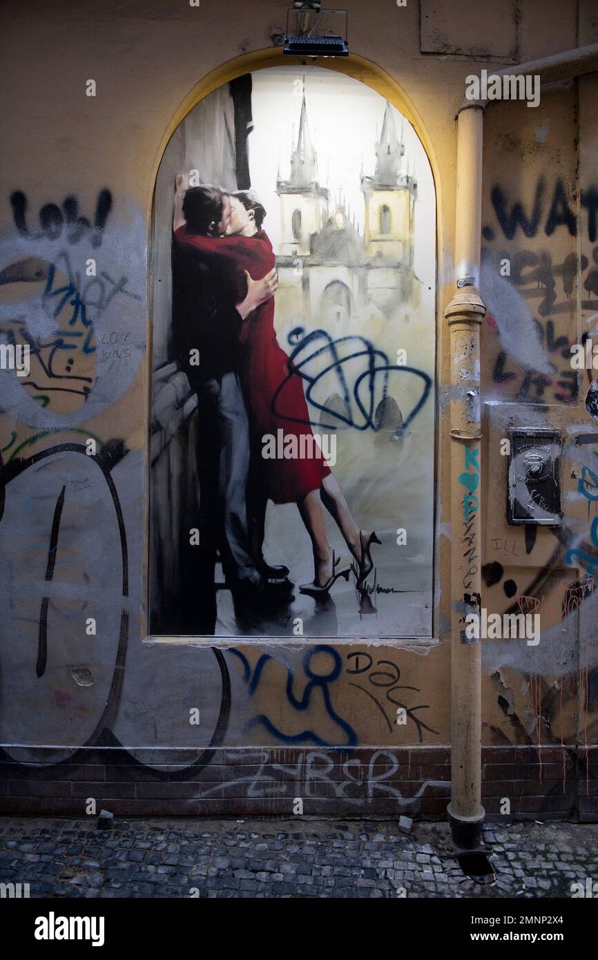 Street art of lovers kissing with graffiti, under Charles Bridge ...