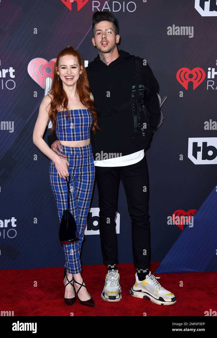 Madelaine Petsch, left, and Travis Mills arrive at the iHeartRadio ...