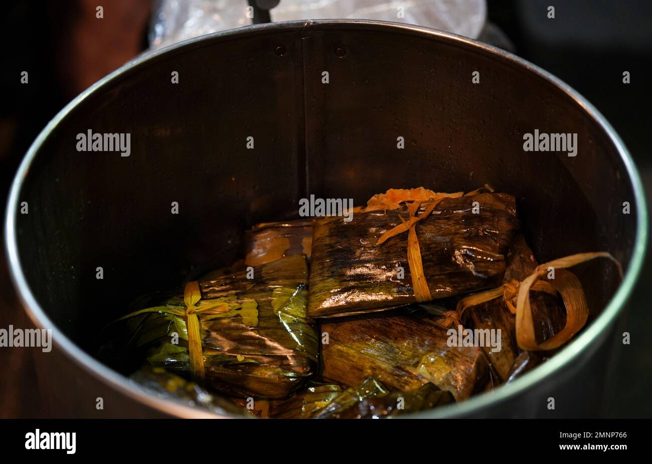 A pot full of Oaxaca style tamales waits for customers at a street ...