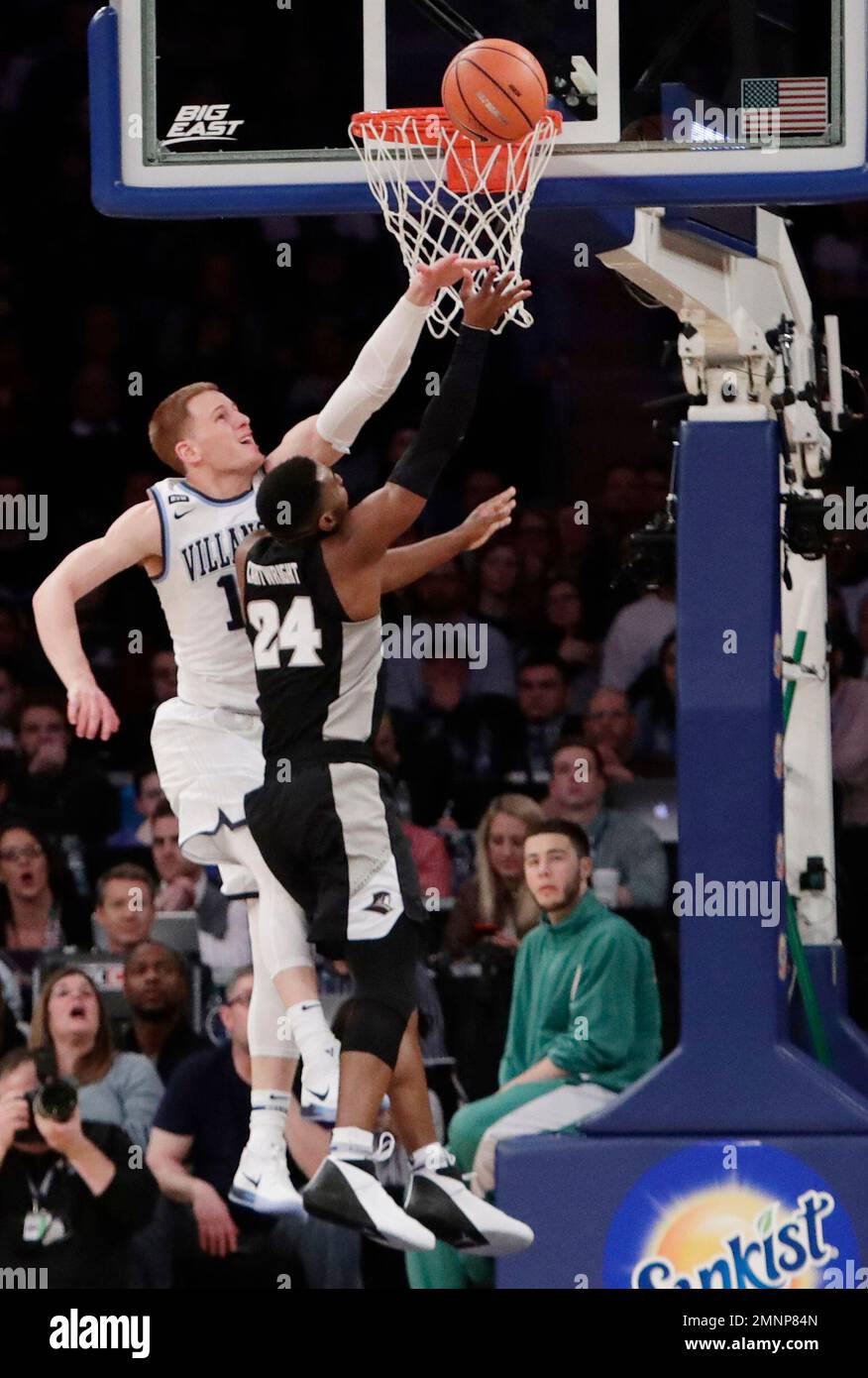 Providence's Kyron Cartwright (24) drives past Villanova's Donte ...