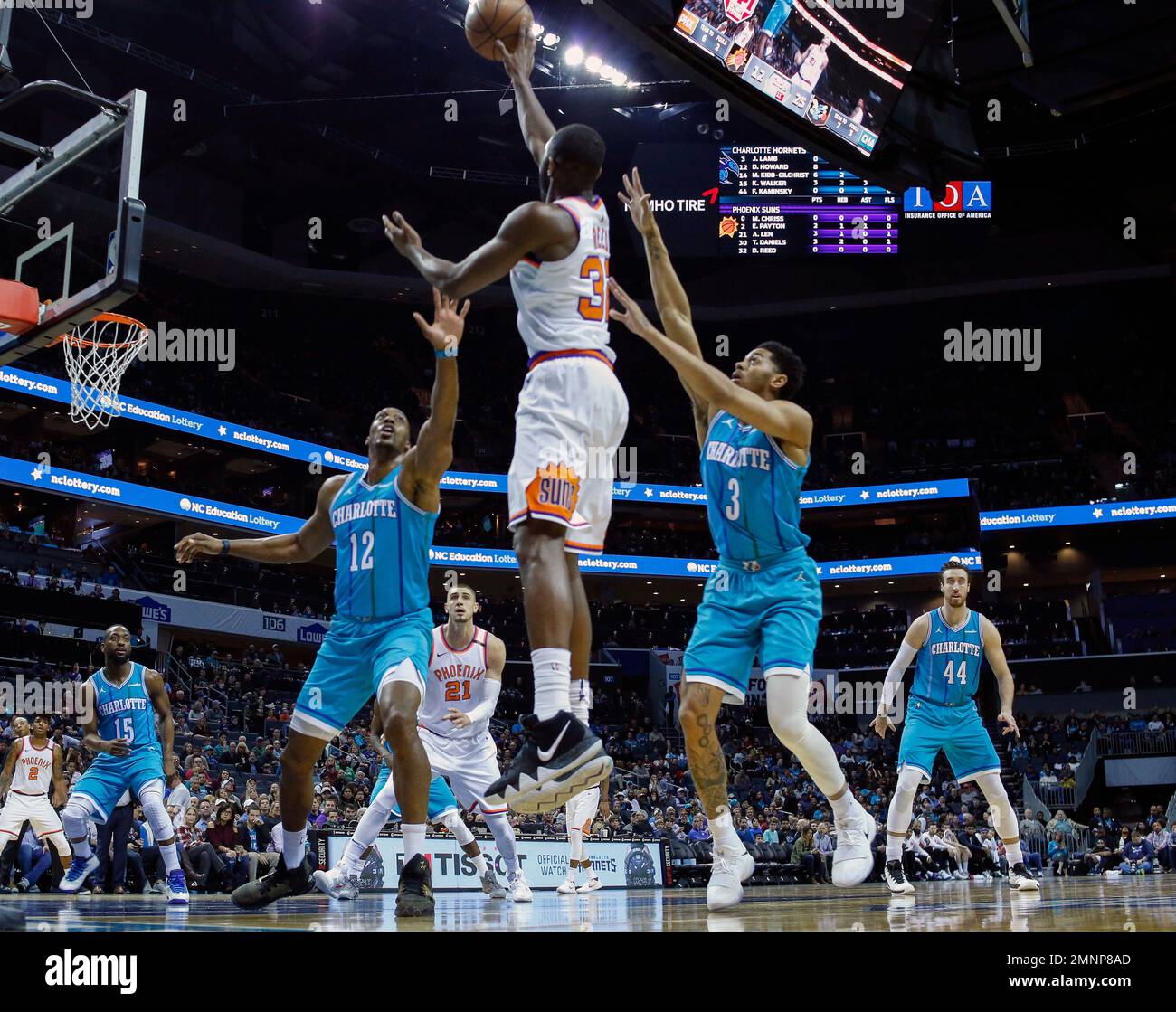 Phoenix Suns guard Davon Reed, center, shoots over the double team by ...