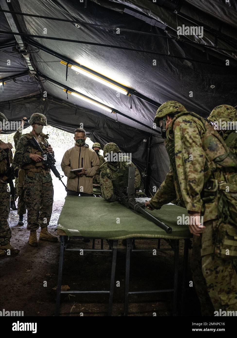 Soldiers with the Japan Ground Self-Defense Force present an M2 ...