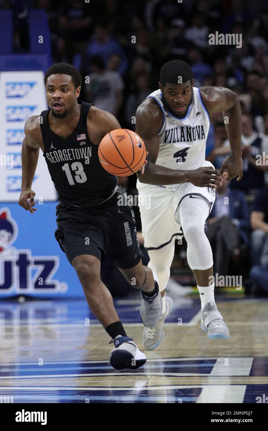Georgetown's Trey Dickerson, left, drives up the court with Villanova's ...