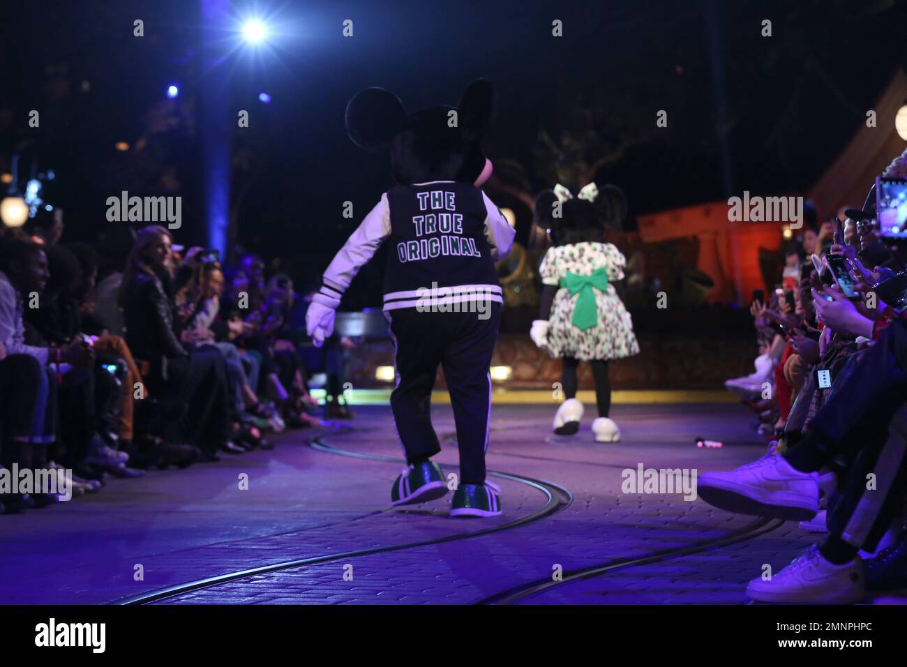 Disney's characters Mickey and Minnie Mouse walk down the runway at the ...