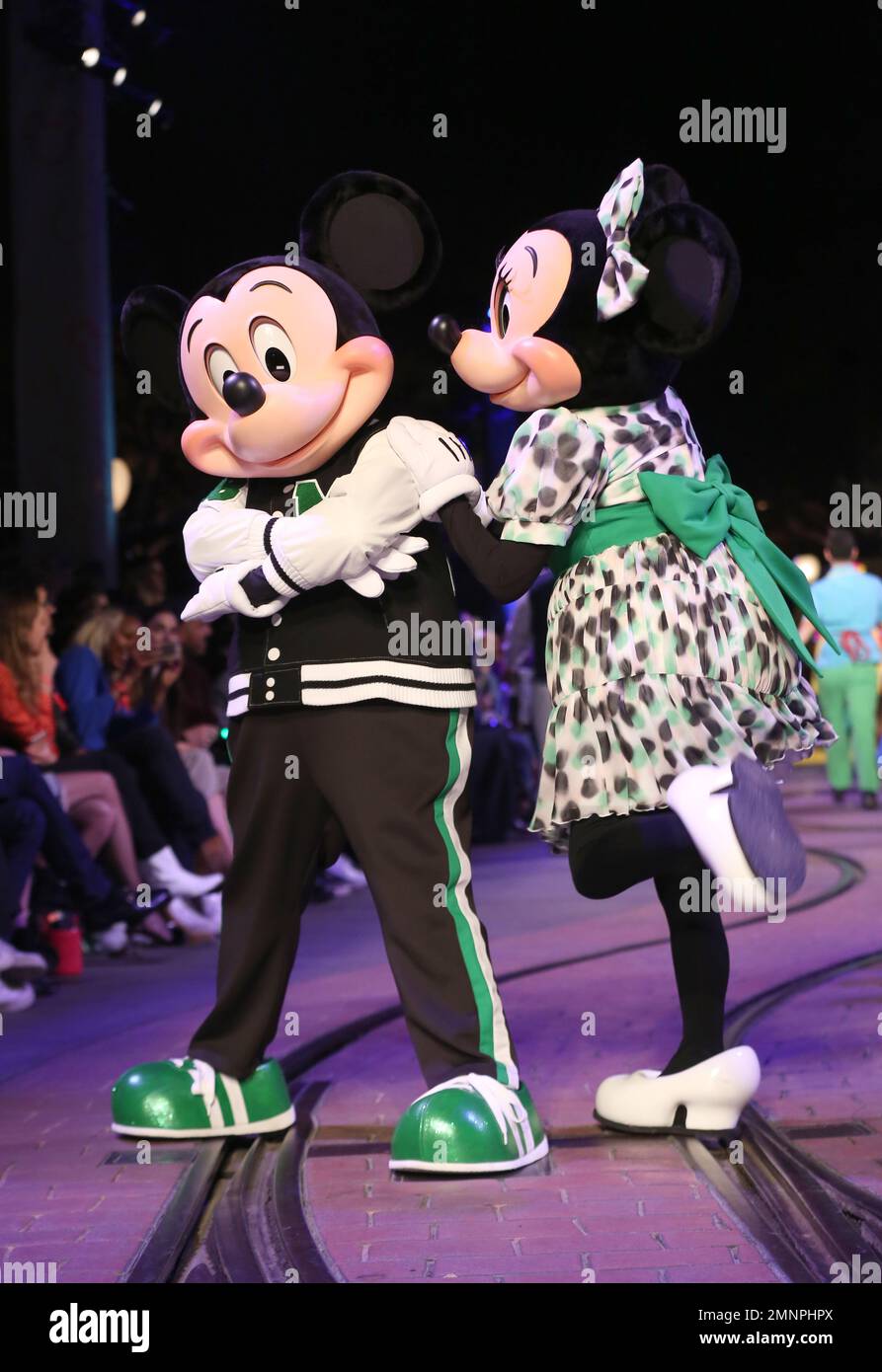 Disney's characters Mickey and Minnie Mouse walk down the runway at the ...