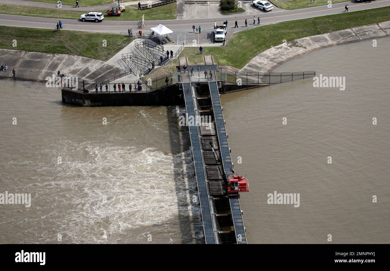 Workers open the gates of the Bonnet Carre spillway, a river diversion ...