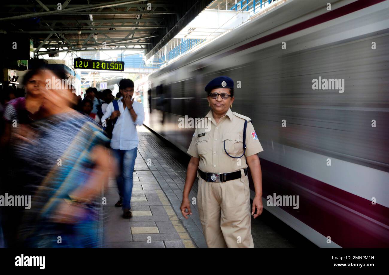 A woman railway police officer stands at Matunga Road train station on ...