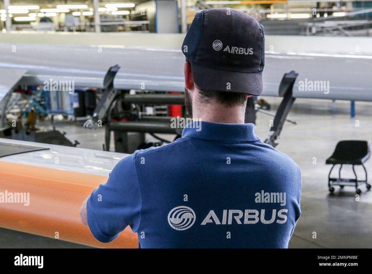 A worker on Airbus' double-deck A380 assembly line stands near a plane ...