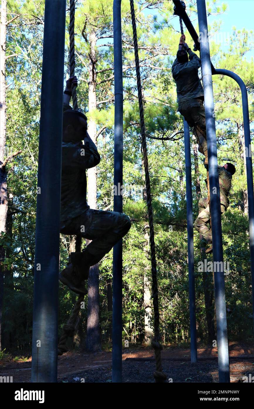 U.S. Soldiers climb ropes at the All American Mile obstacle course ...