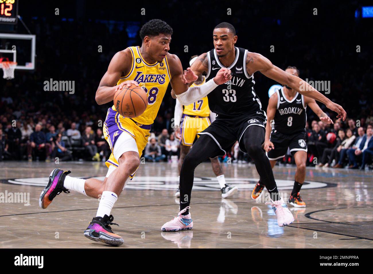 Los Angeles Lakers forward Rui Hachimura, left, drives against Brooklyn Nets center Nic Claxton ...