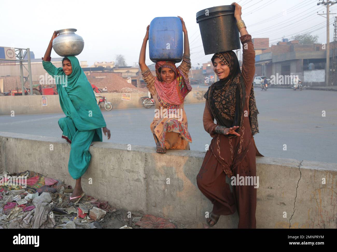 Pakistani girls living in Lahore's slums carry clean water ahead of ...