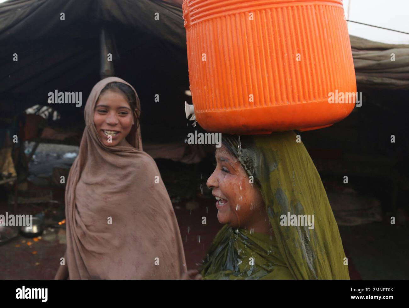 Pakistani girls living in Lahore's slums carry clean water ahead of ...